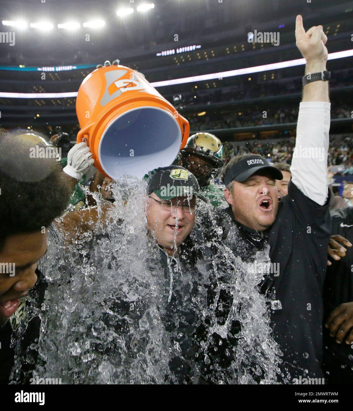 DeSoto head coach Todd Peterman, left, is doused with assistant coach ...
