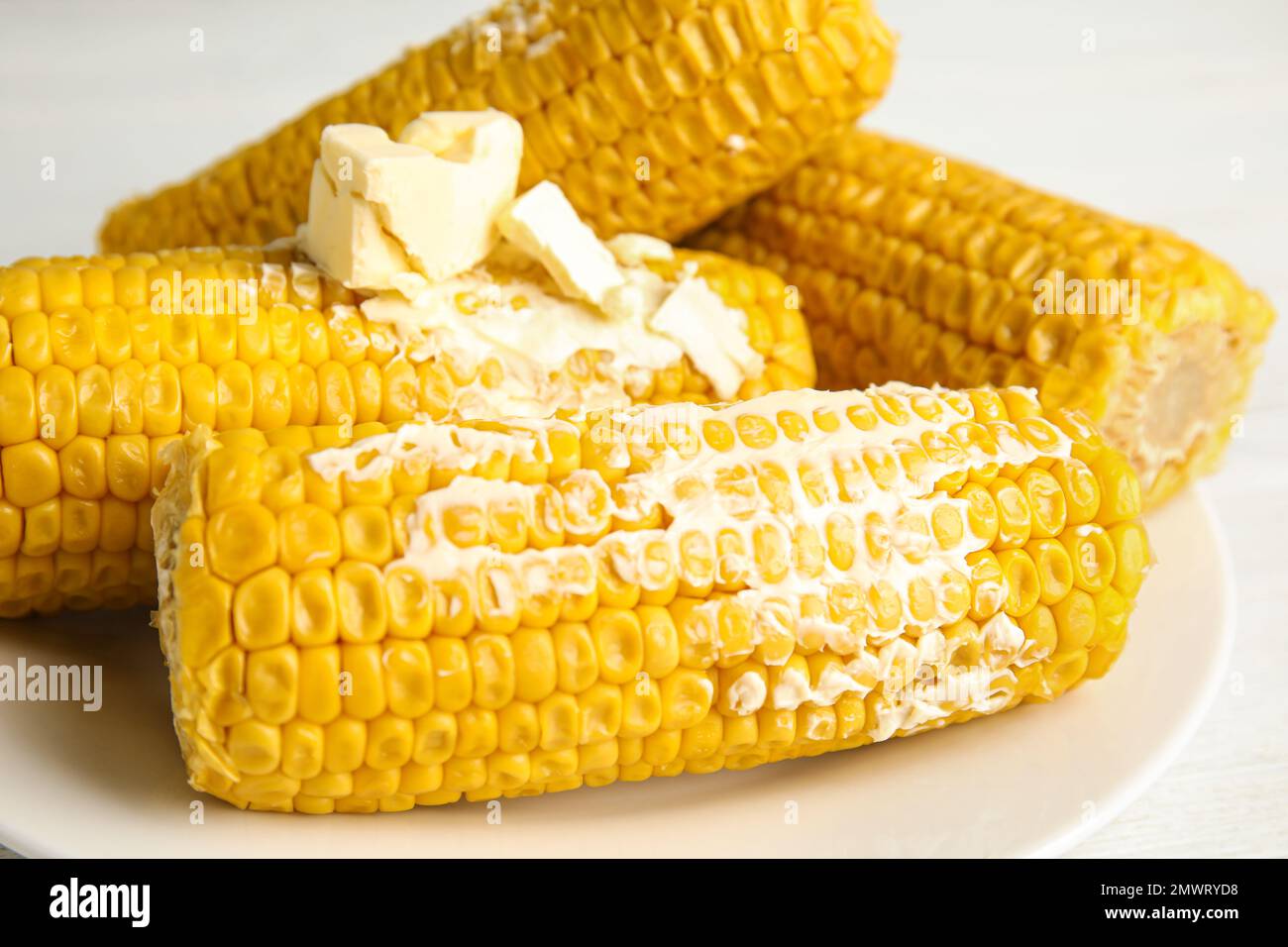 Delicious boiled corn with butter on plate, closeup Stock Photo - Alamy