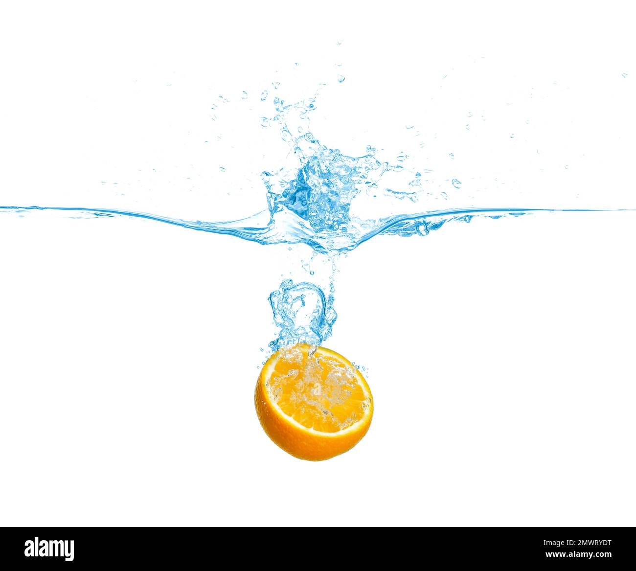 Ripe orange falling down into clear water with splashes against white ...