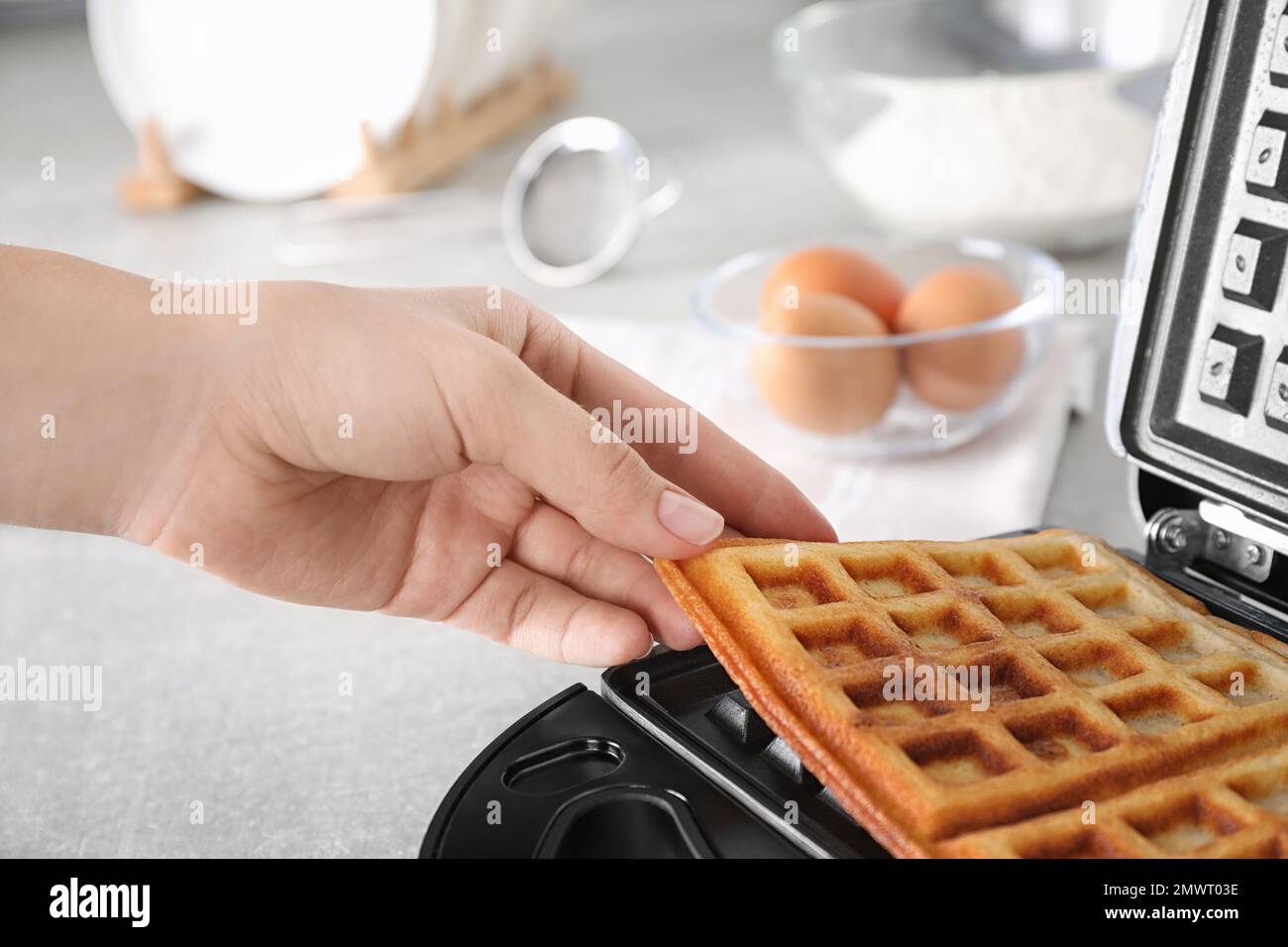 Taking waffles from waffle maker hi-res stock photography and images ...