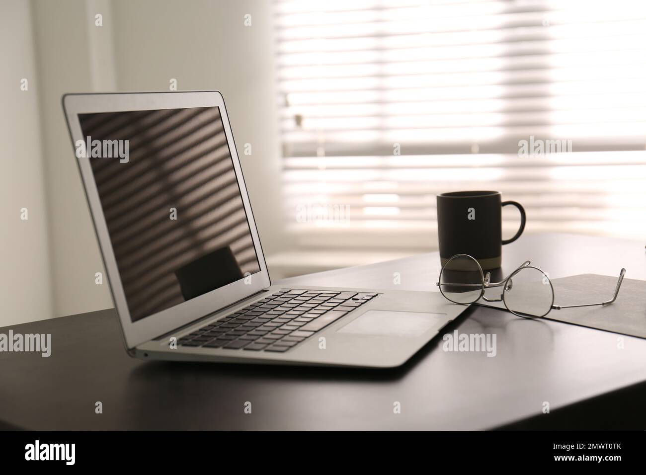 Modern laptop on office table. Stylish workplace Stock Photo - Alamy
