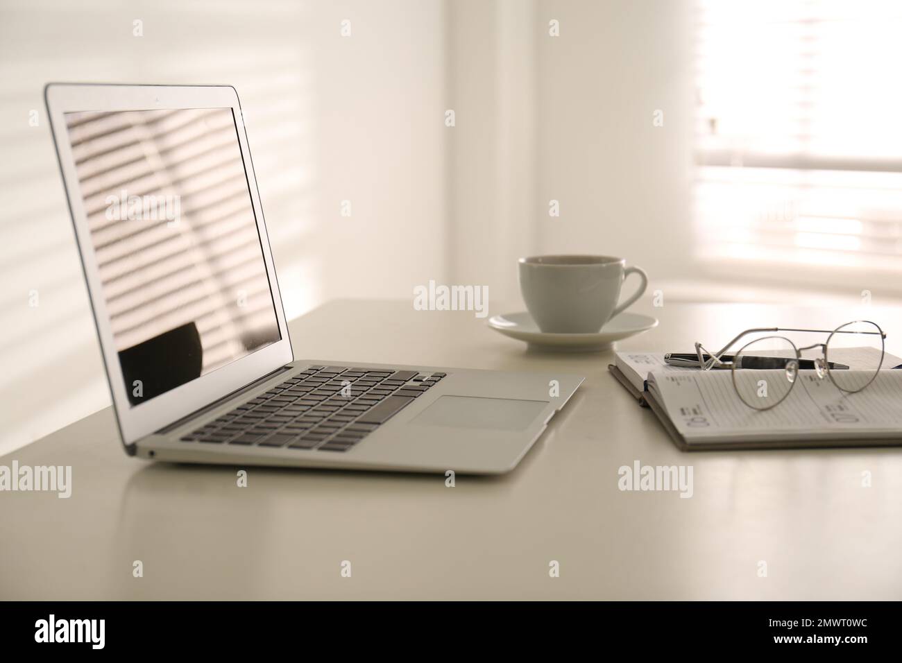 Modern laptop on office table. Stylish workplace Stock Photo - Alamy
