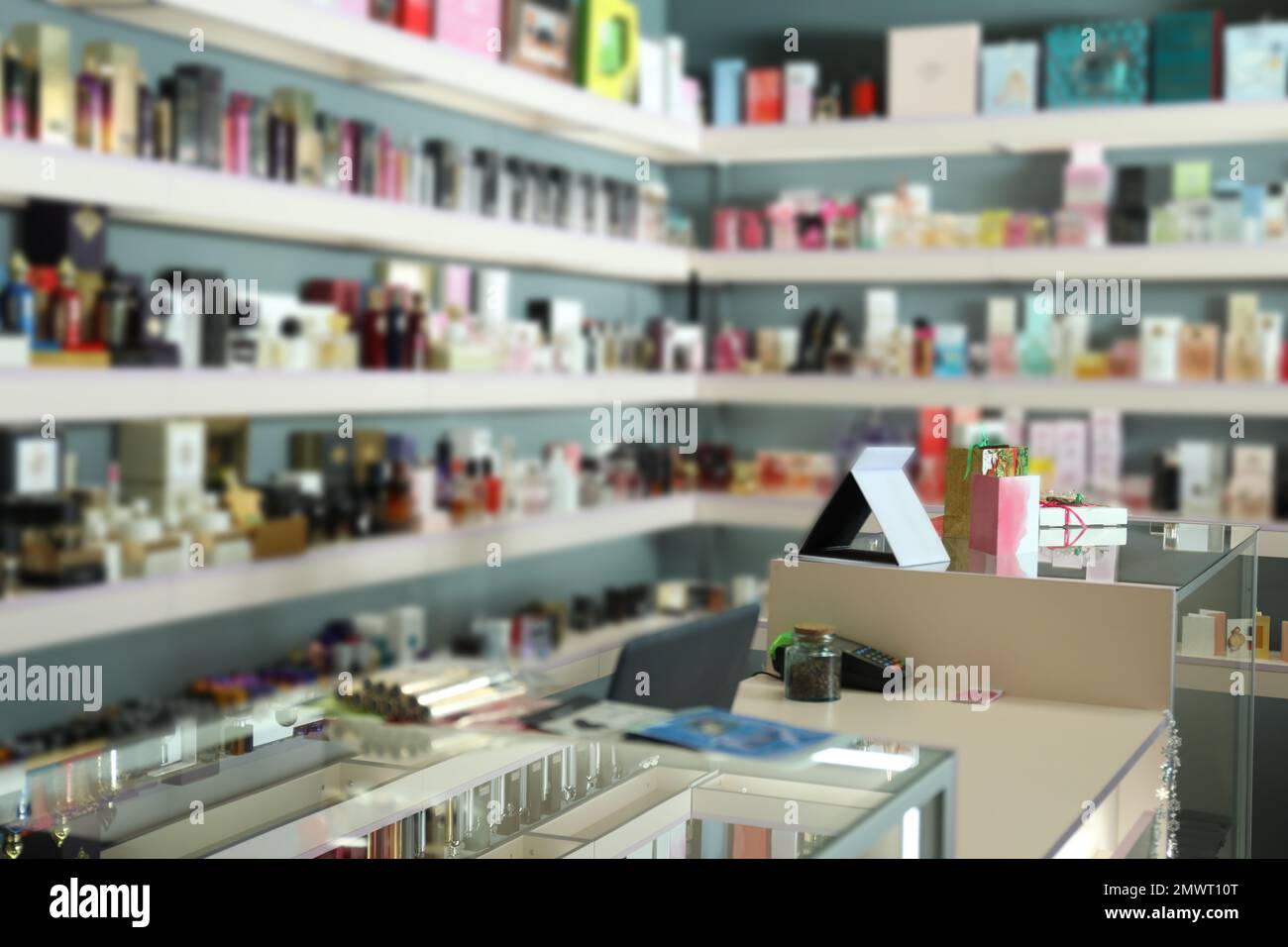 Counter and shelves with perfume bottles in shop Stock Photo - Alamy