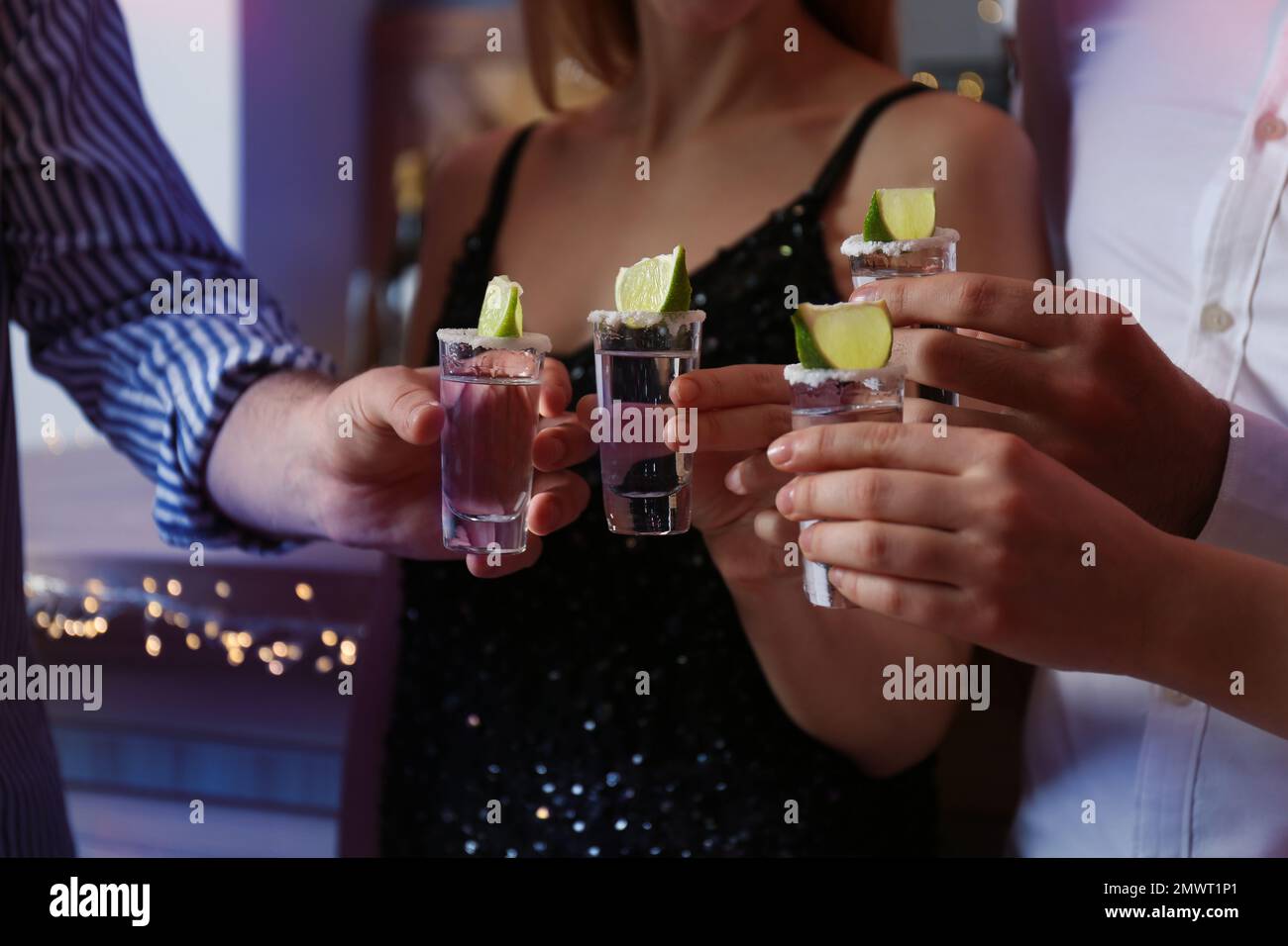 Young people toasting with Mexican Tequila shots in bar, closeup Stock ...