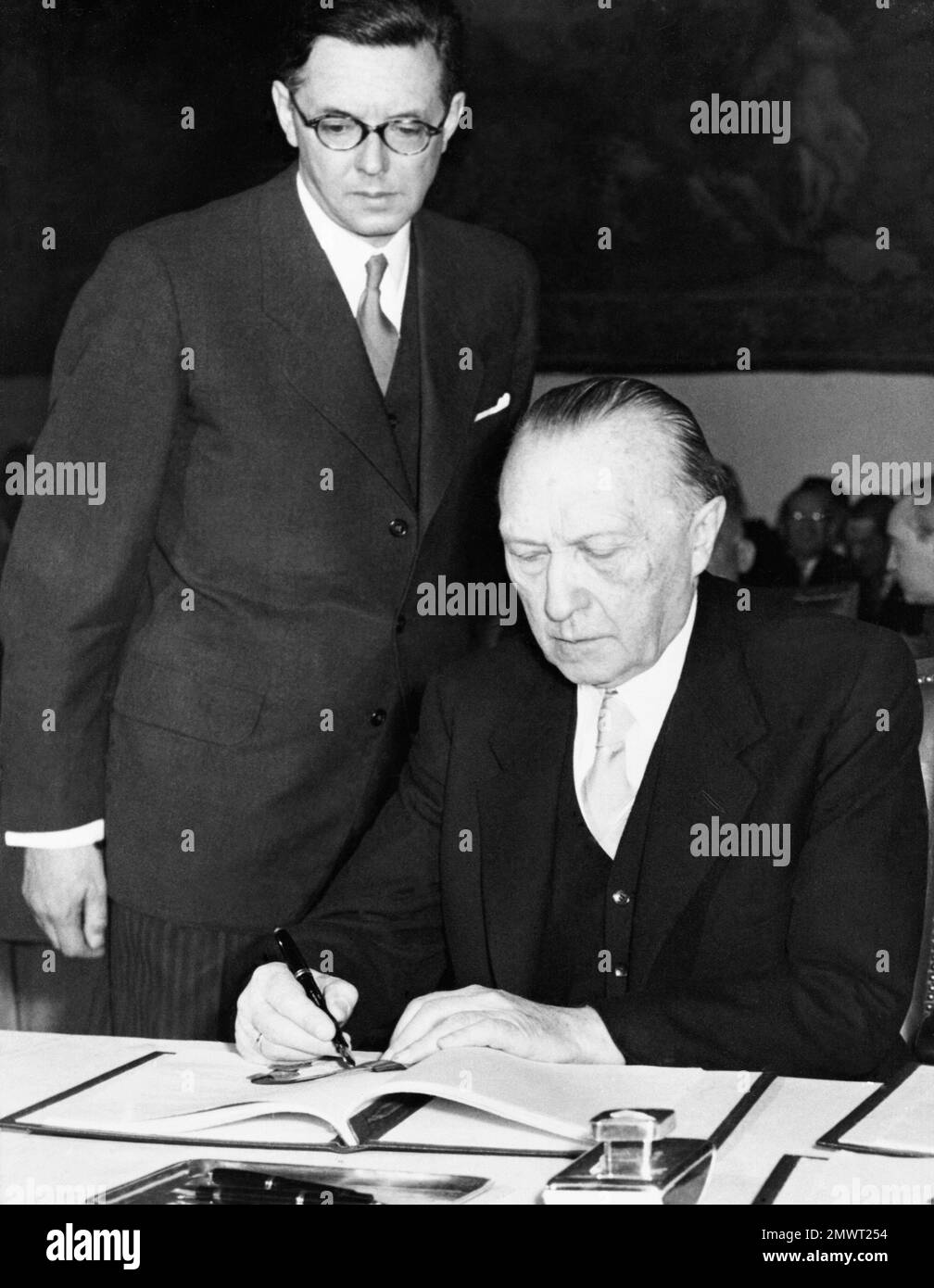 West German Chancellor Konrad Adenauer, signs the Peace Contract ...