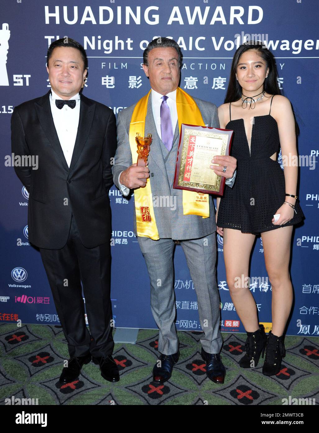 Sylvester Stallone, winner of the lifetime achievement award, center, Geng Dong, VP of Global ...
