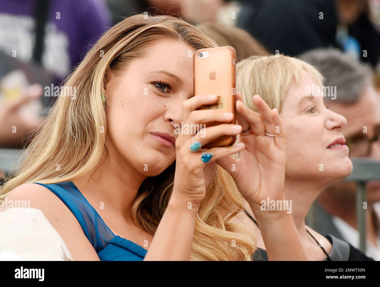 Actress Blake Lively points her iPhone at photographers during a ...
