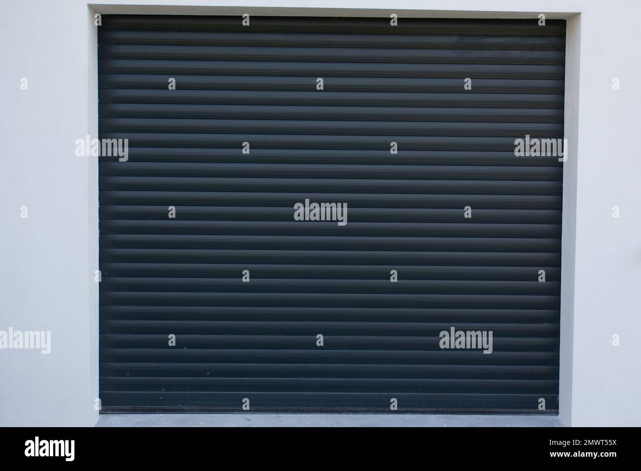 Automatic roller garage gate access to house garage for a car with grey ...