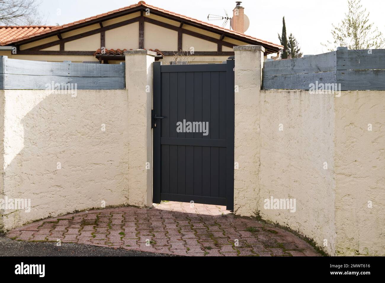 pedestrian entrance door in the garden of the house modern grey single ...