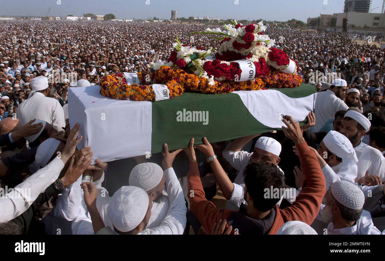 People carry the coffin of Junaid Jamshed, a popular pop singer turned ...