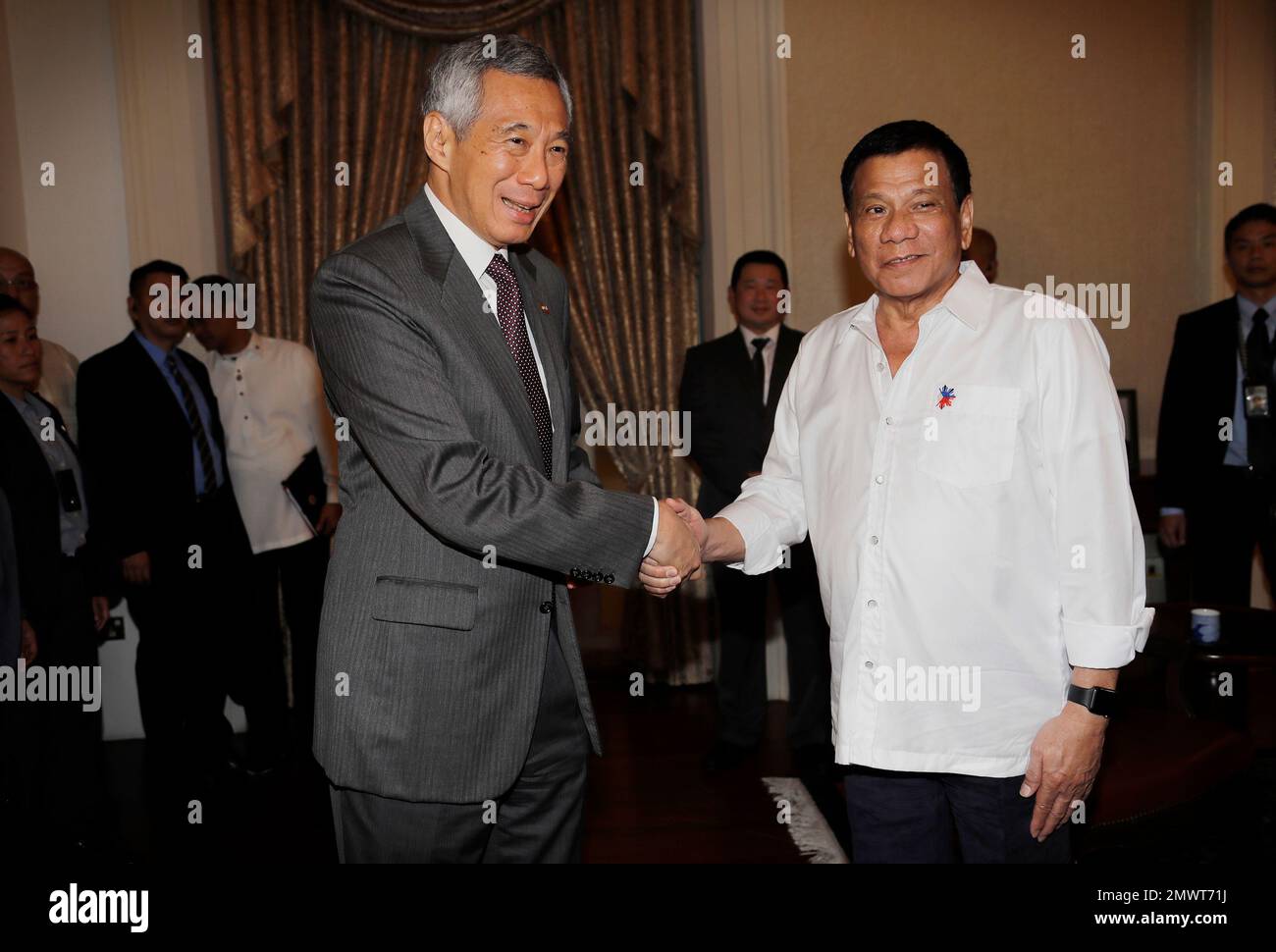 Philippine President Rodrigo Duterte, right, shakes hands with ...