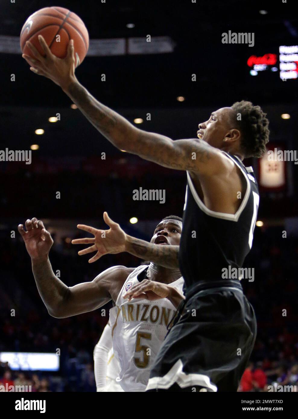 Grand Canyon guard DeWayne Russell shoots over Arizona guard Kadeem ...