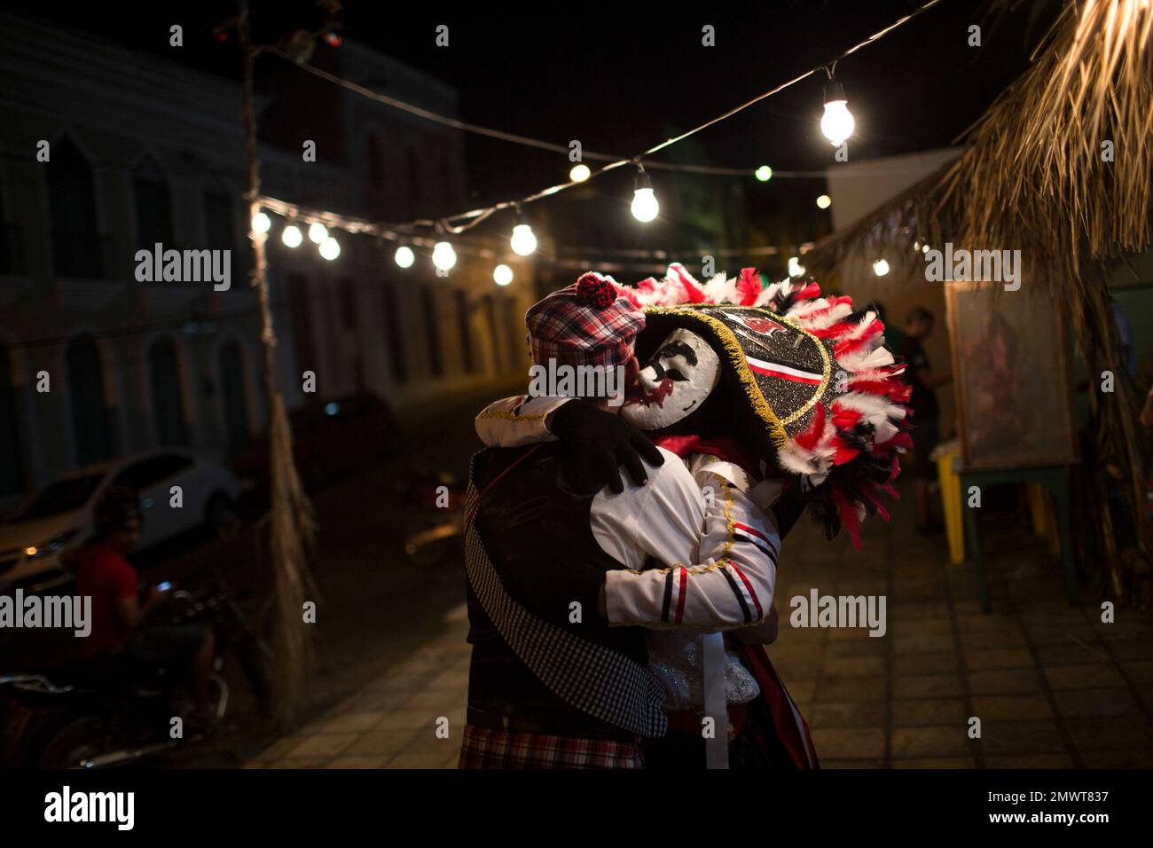 FILE - In this Feb. 8, 2016 file photo, "Careta" embraces a reveler ...