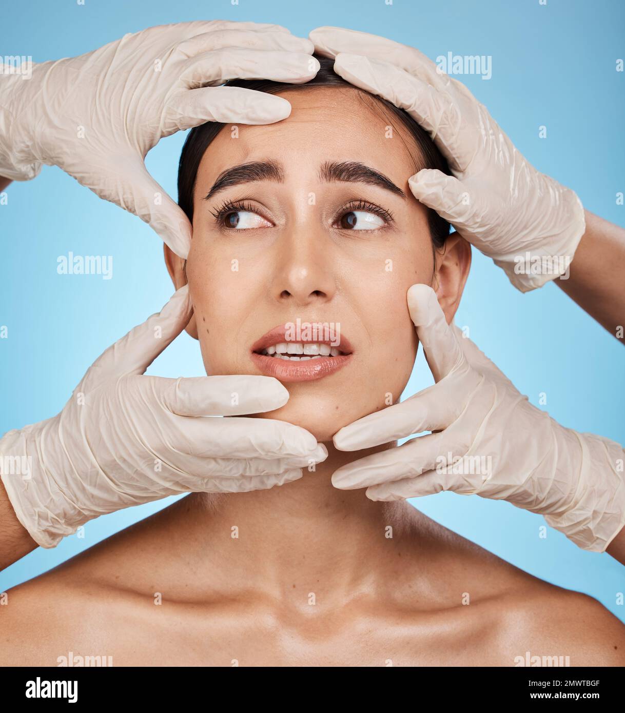 Hands, woman face and plastic surgery, skincare or treatment against a ...