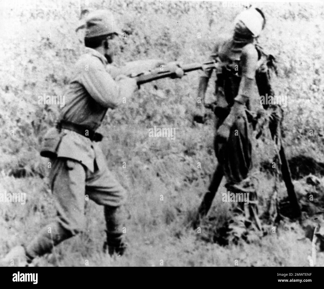 EDS NOTE: GRAPHIC CONTENT A Japanese soldier plunges a bayonet into the ...