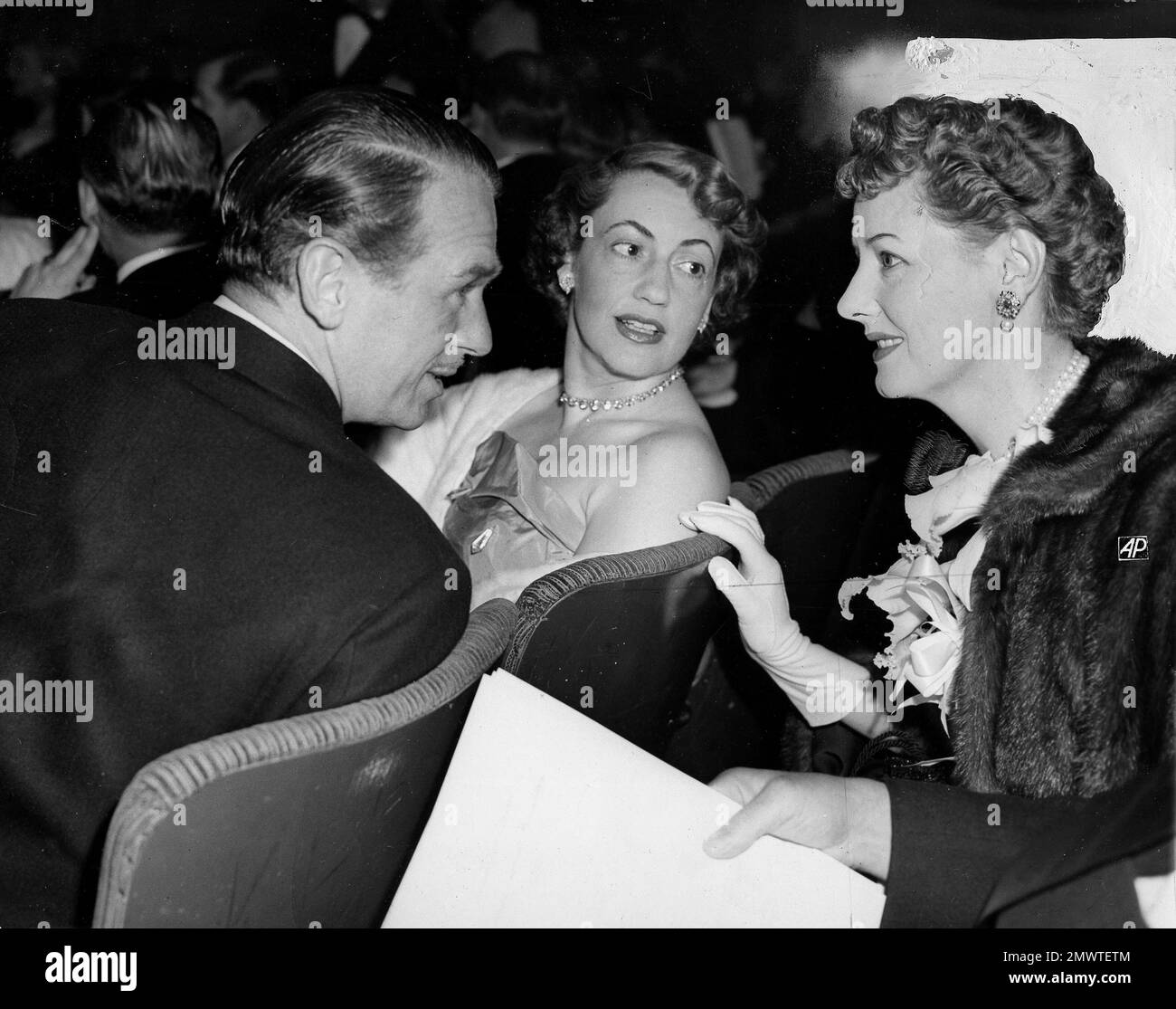 Actor Douglas Fairbanks Jr. turns to talk to actress Irene Dunne at the ...