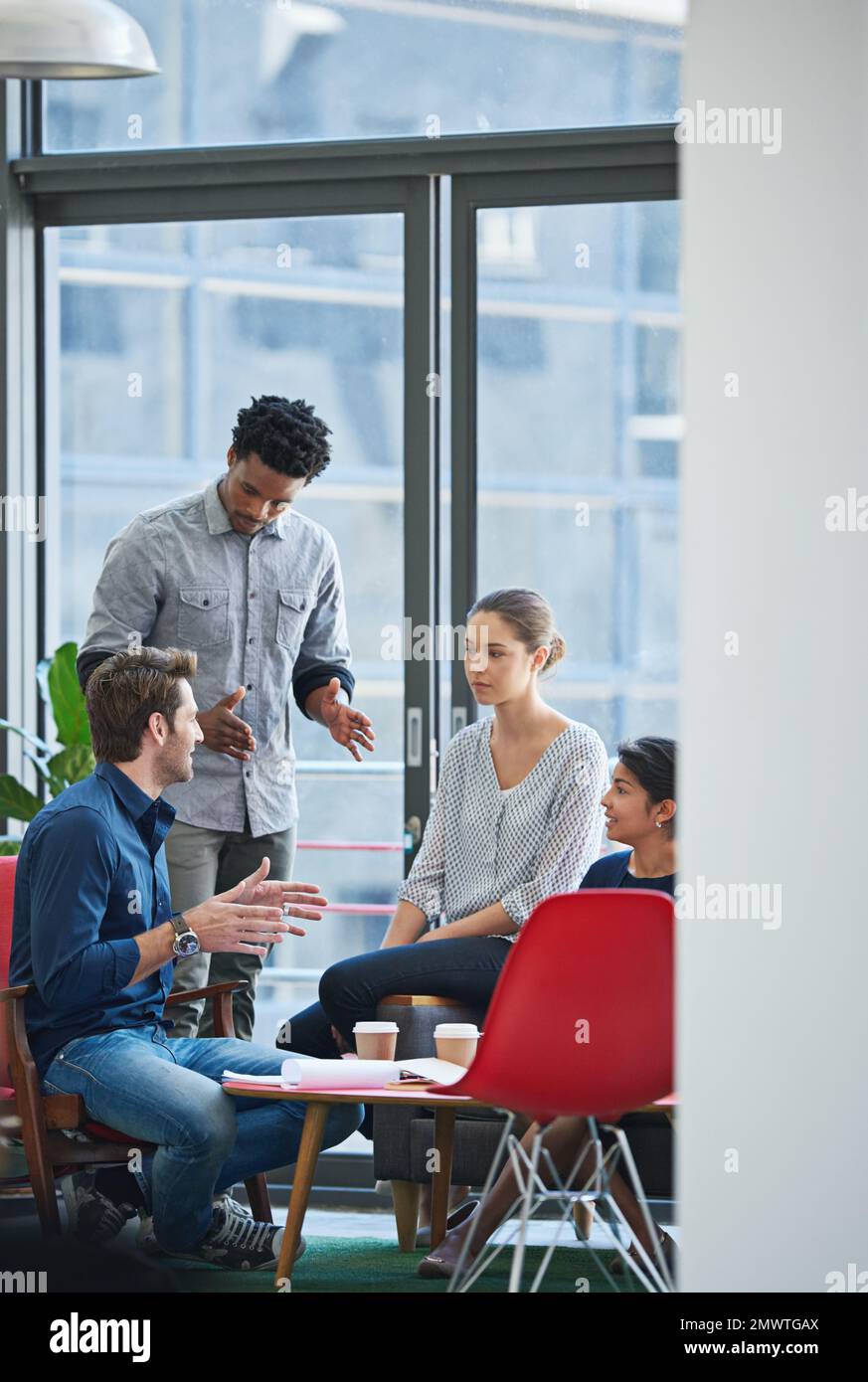 They make ideas reality. a group of office workers talking together in ...