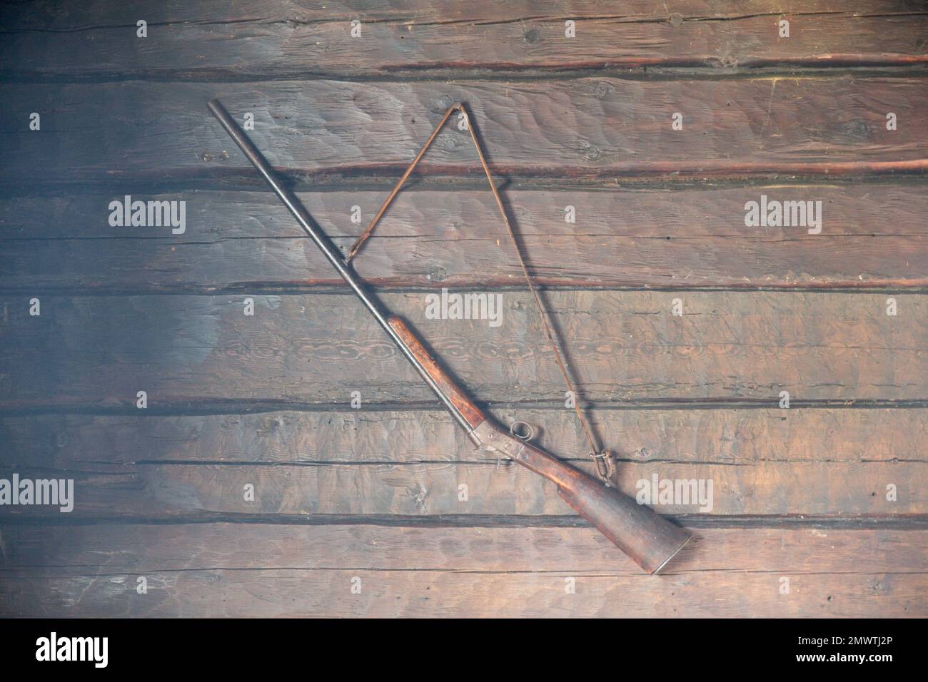 Old hunting gun hanging on wall of wooden building Stock Photo - Alamy