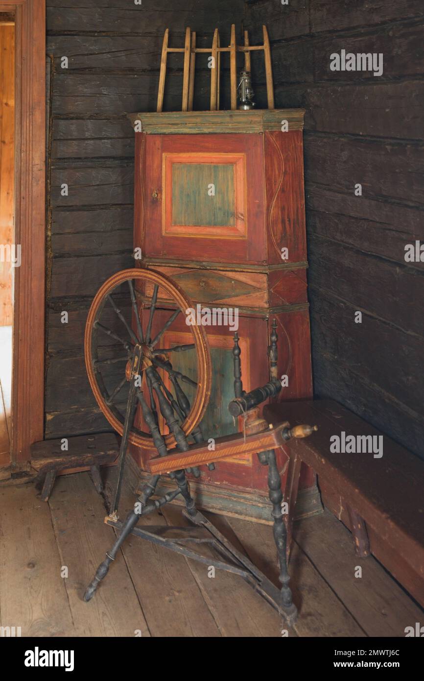 Old wooden spinning wheel in front of vintage cabinet Stock Photo - Alamy
