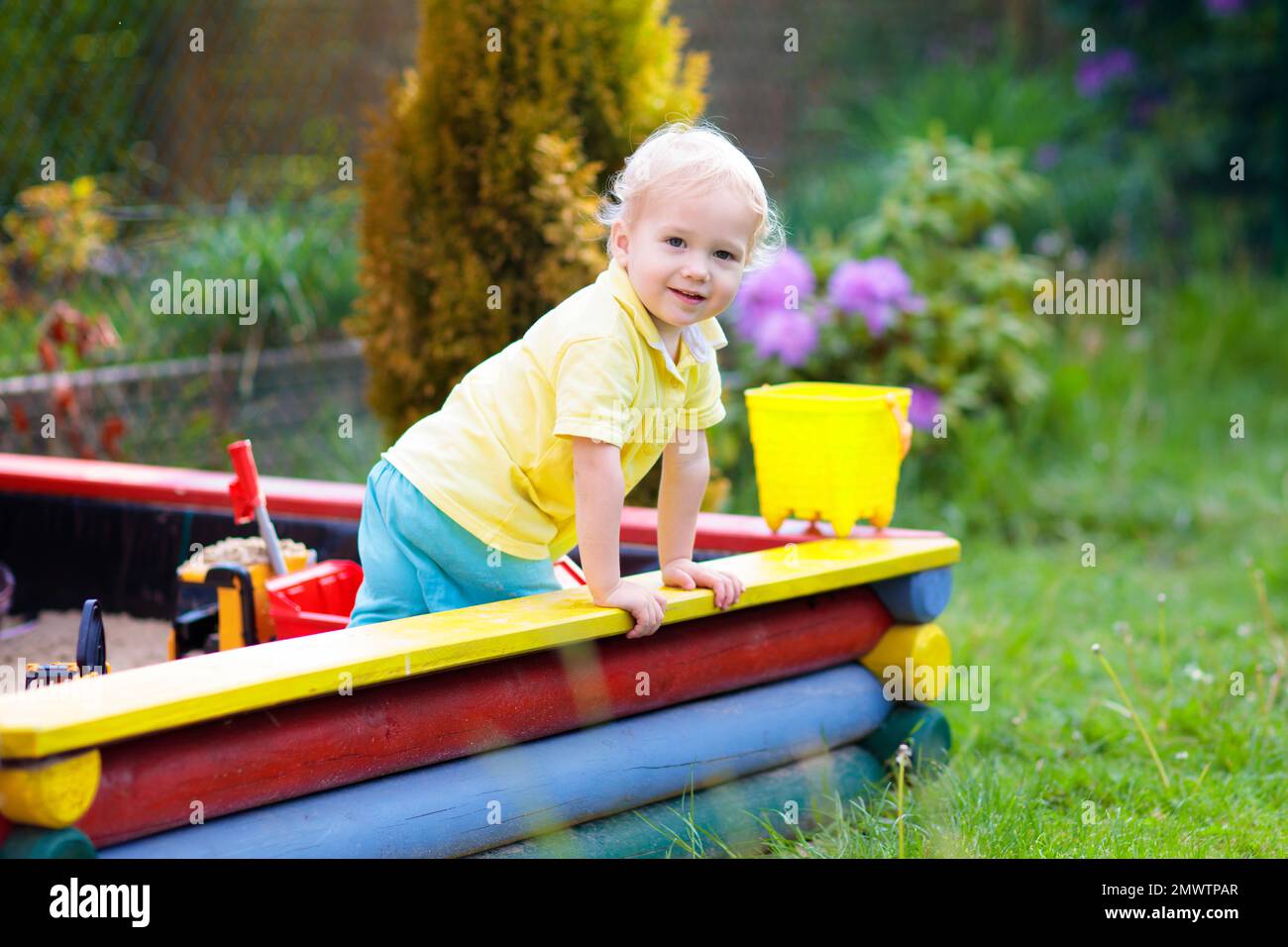 Child in sand box. Kid playing with sand on colorful playground. Active ...