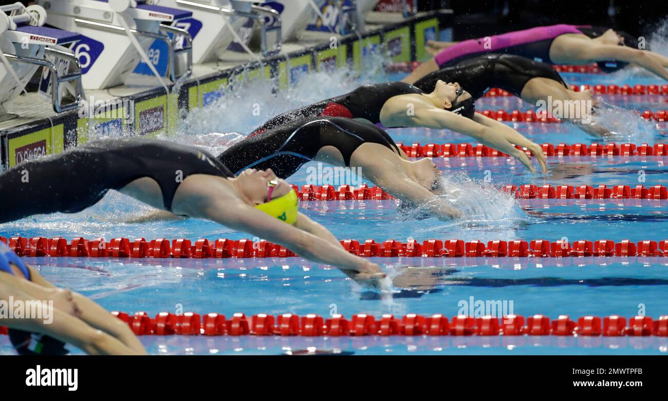 Swimmers dive into the pool at the start of the women's 4x100-meter ...
