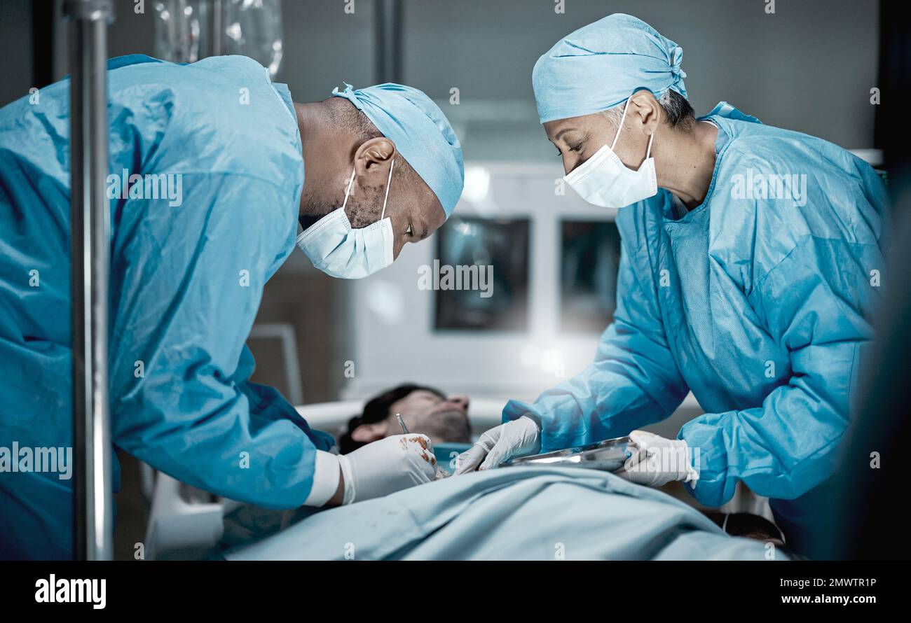 Healthcare, surgery and doctors in hospital operating room for ...