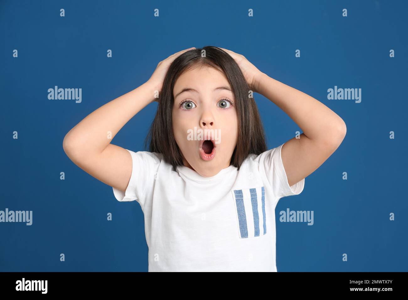Portrait of cute little girl on blue background Stock Photo - Alamy