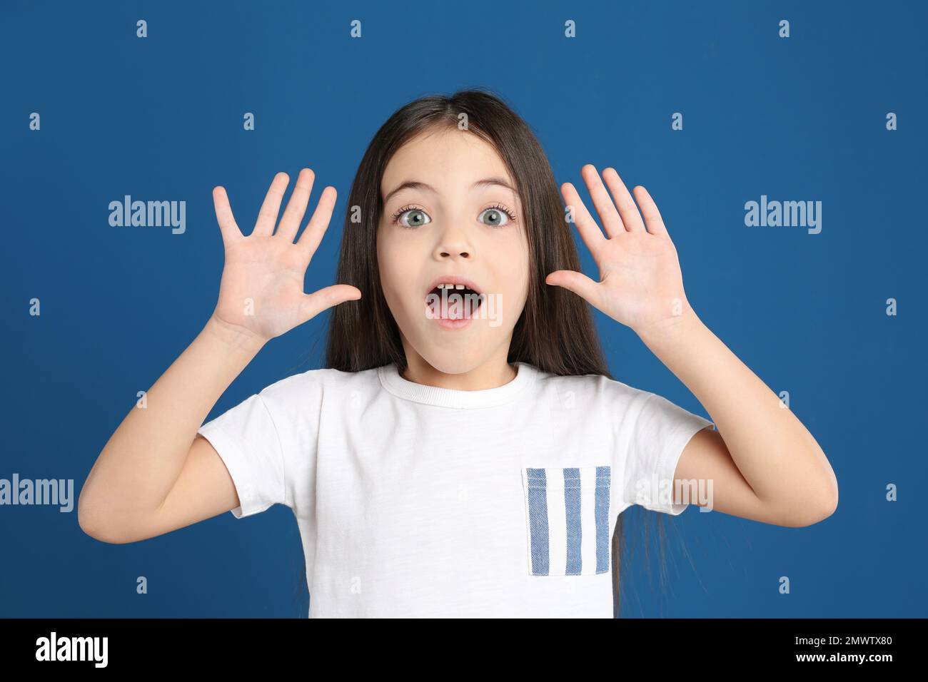 Portrait of cute little girl on blue background Stock Photo - Alamy