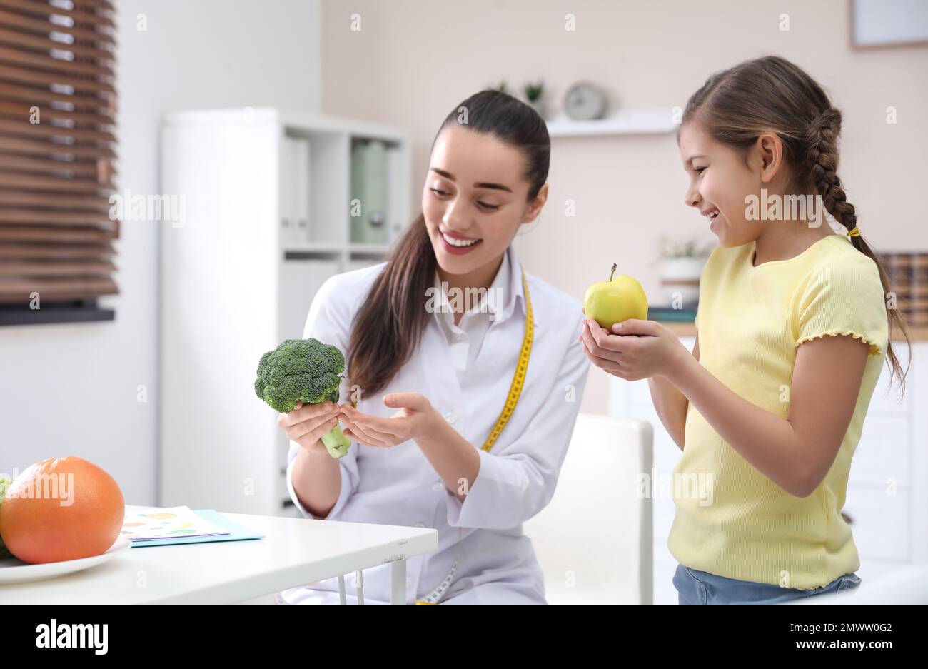 Little girl visiting professional nutritionist in office Stock Photo ...