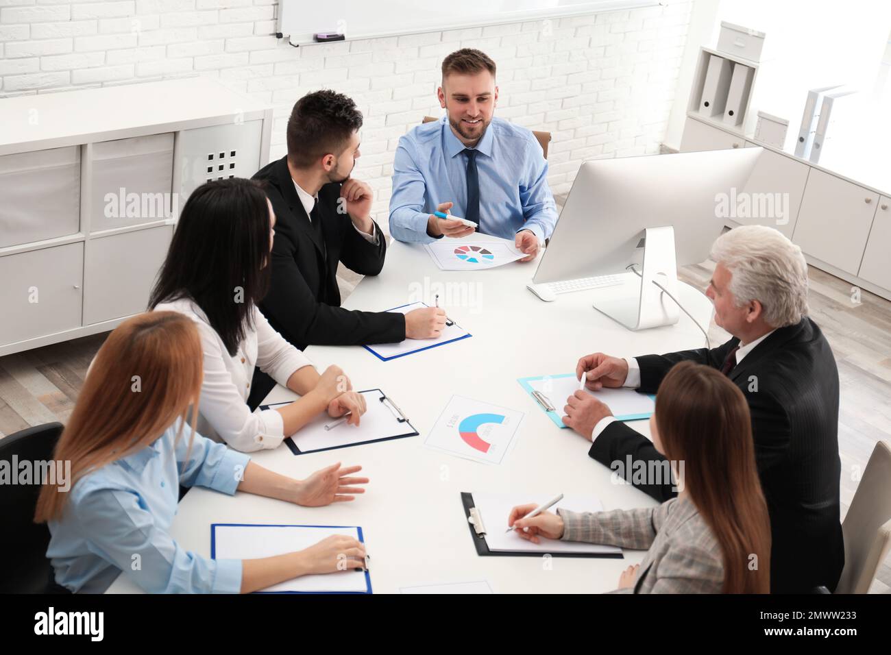 Professional business trainer working with people in office Stock Photo ...