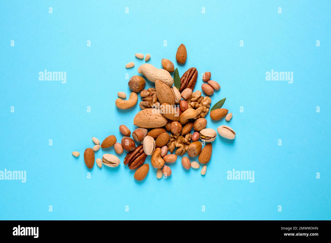 Different delicious nuts on light blue background, flat lay Stock Photo ...