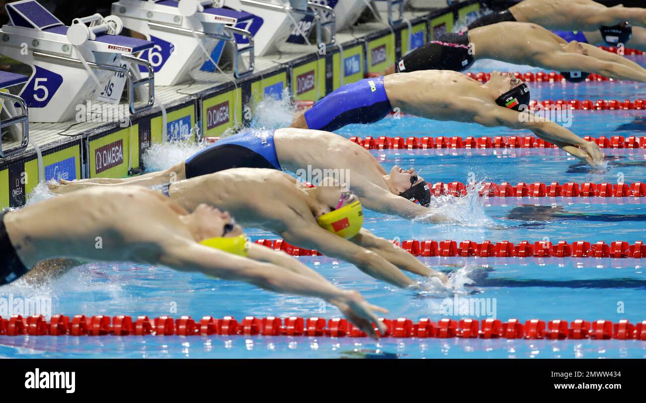 Swimmers dive into the pool to start the men's 4x50-meter medley final ...