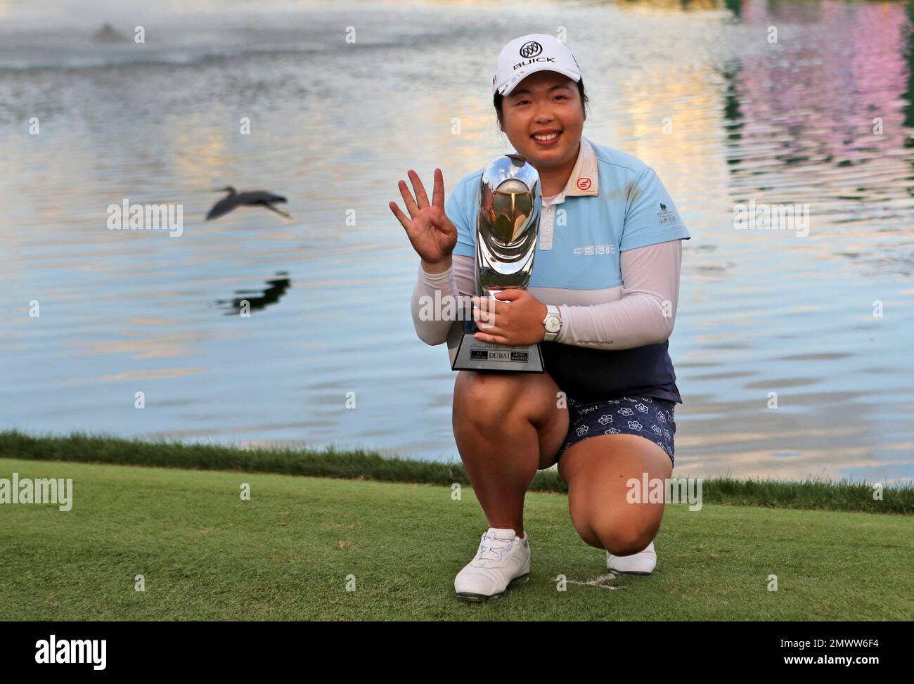Shanshan Feng of China holds the trophy after she won the Dubai Ladies ...