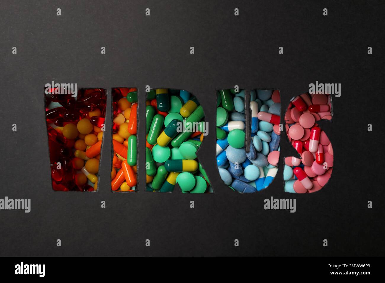 Word VIRUS cut out of black paper over pills, top view Stock Photo - Alamy