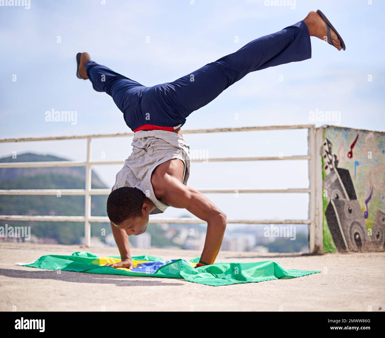 Showing off his skill. Low angle shot of a young male breakdancer in an ...