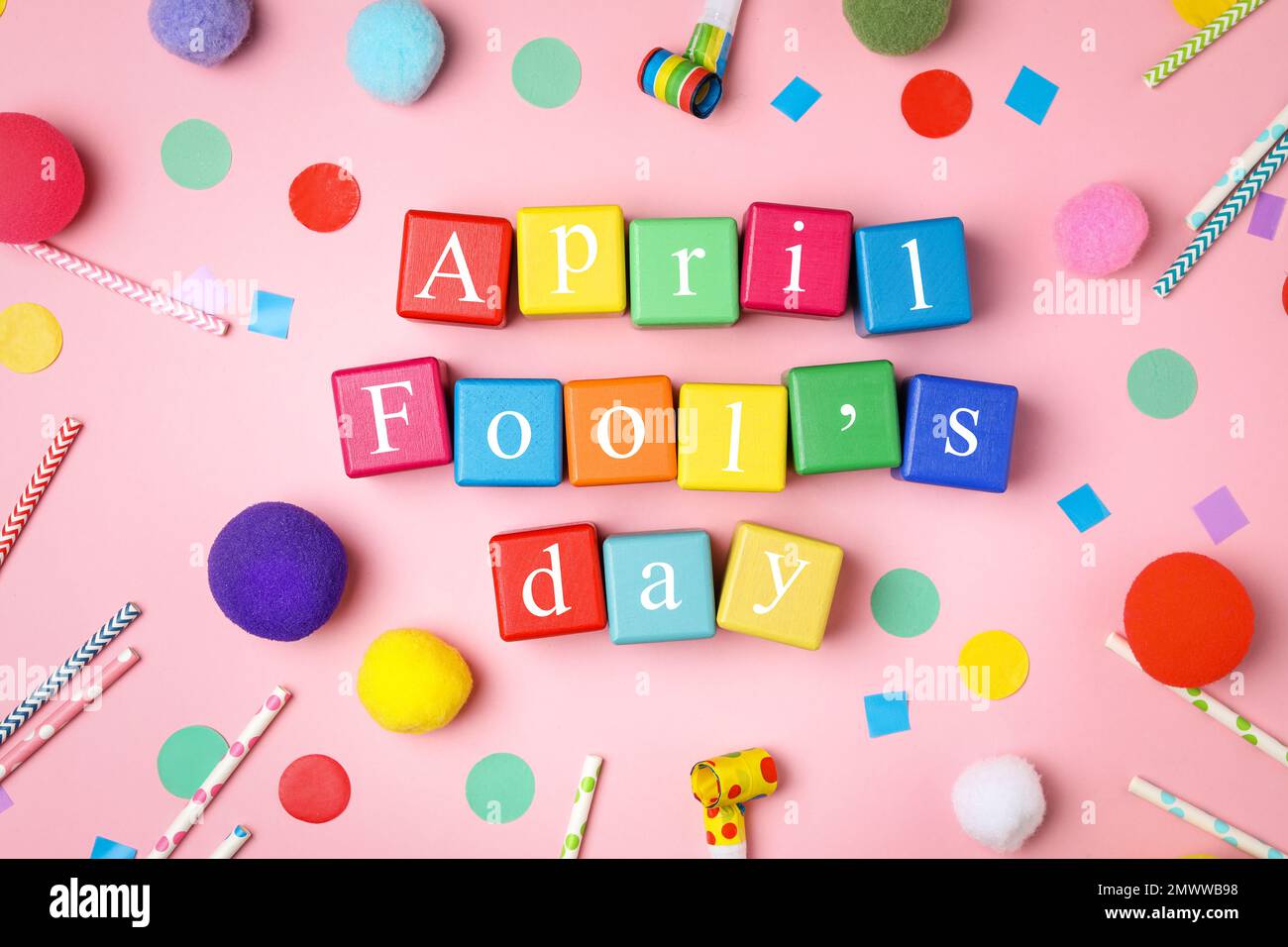 Colorful cubes with words APRIL FOOL'S DAY on pink background, flat lay ...