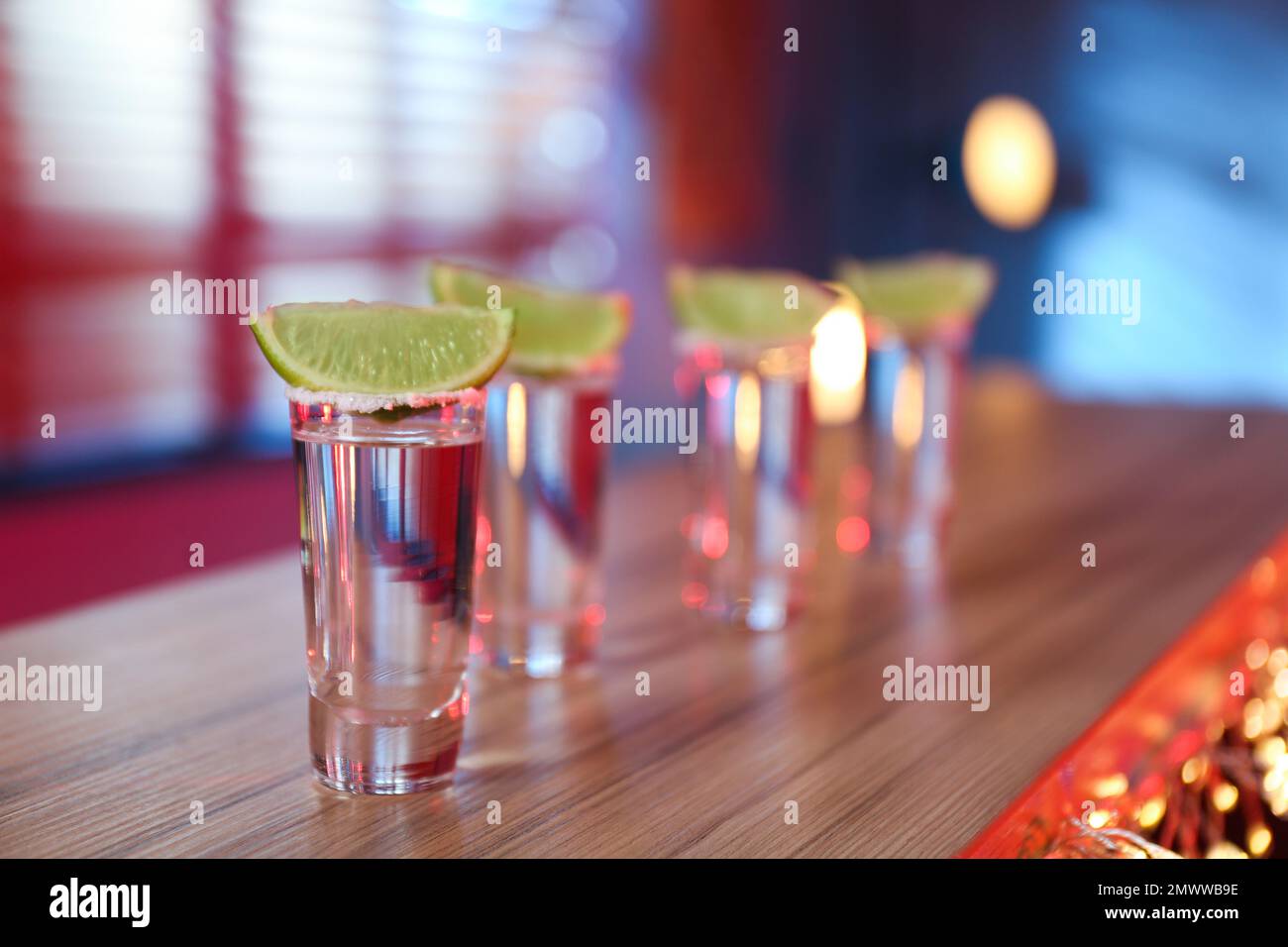 Mexican Tequila with salt and lime slices on bar counter. Space for ...