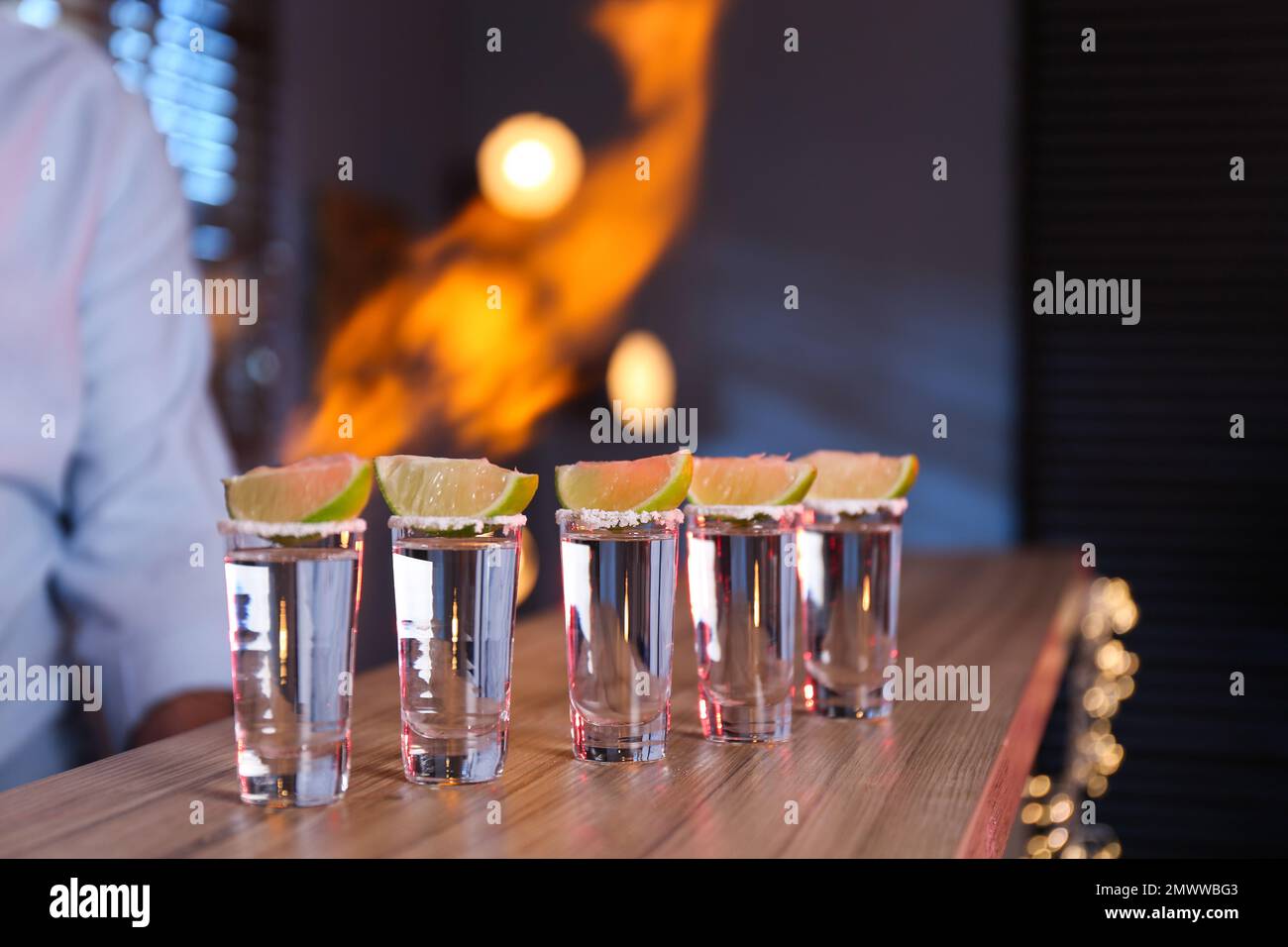 Mexican Tequila shots with lime slices on bar counter Stock Photo - Alamy