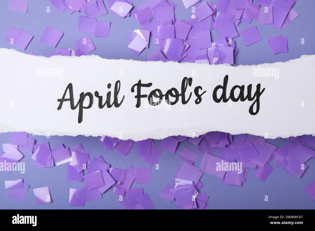 Paper note with phrase APRIL FOOL'S DAY and confetti on lilac ...