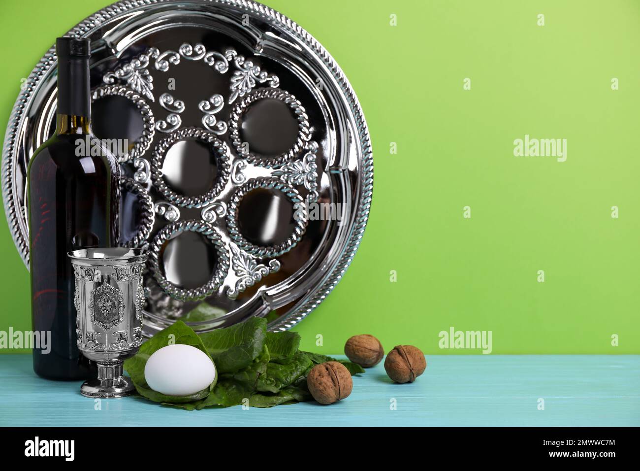 Symbolic Pesach (Passover Seder) items on light blue wooden table ...