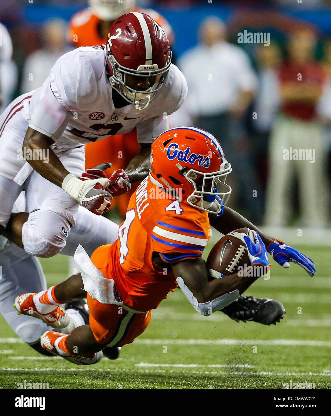 Florida wide receiver Brandon Powell (4) is tackled by Alabama ...