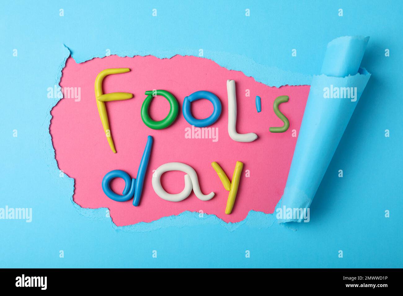 Flat lay composition with words FOOL'S DAY made of clay on color ...