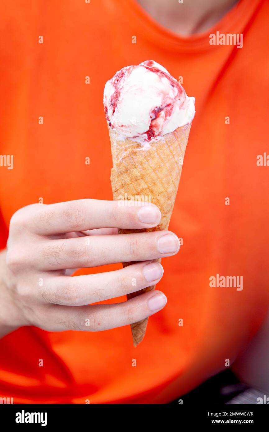 Hand holding gelato cone ice cream in two hands Stock Photo - Alamy