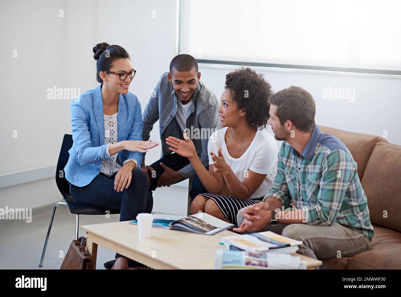 Expressing ideas. a group of designers having a meeting around a coffee ...