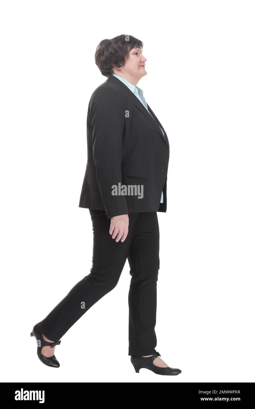 Mature business woman in a pantsuit striding forward Stock Photo - Alamy