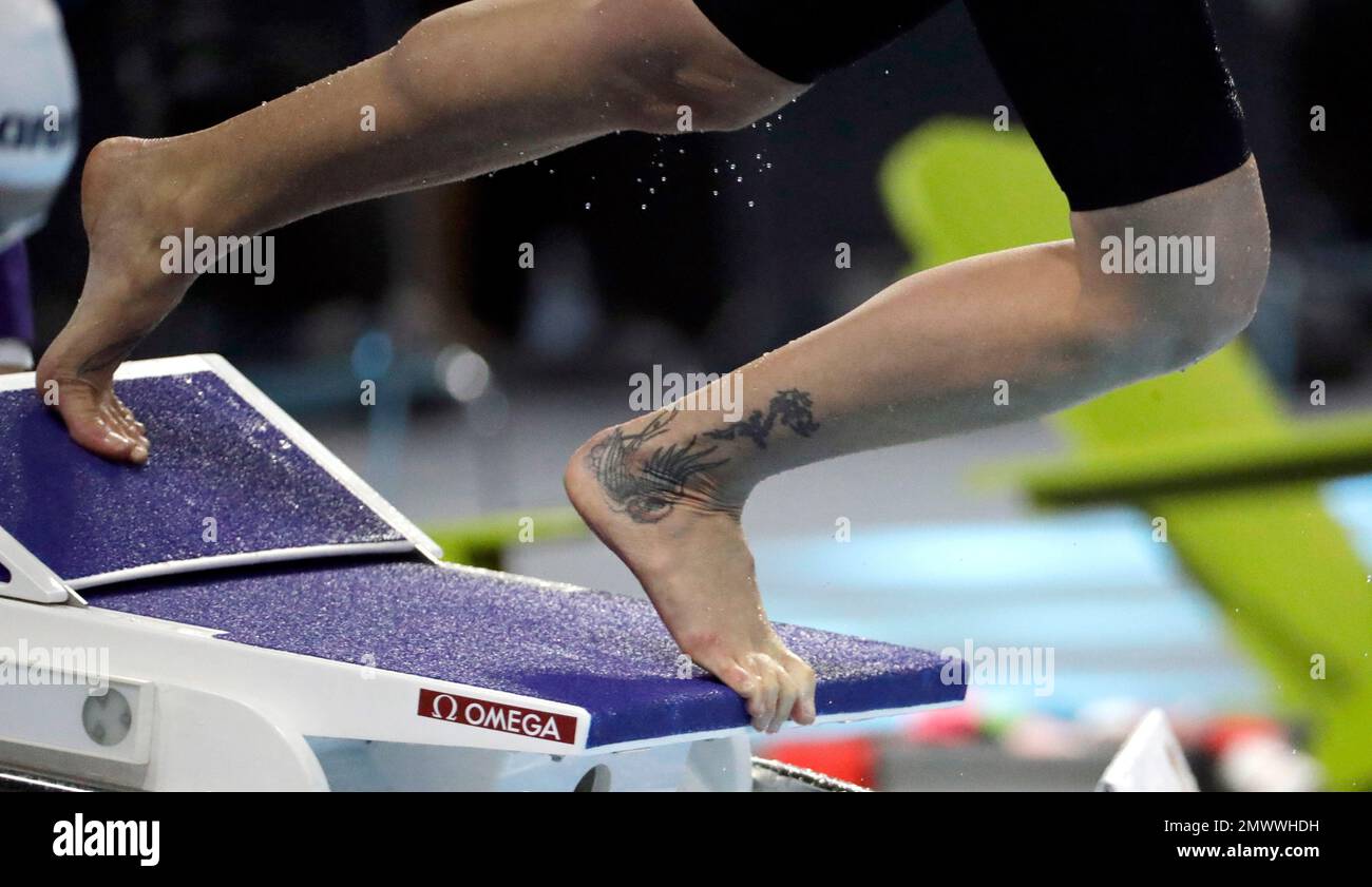 Federica Pellegrini of Italy dives into the pool as she competes in a ...