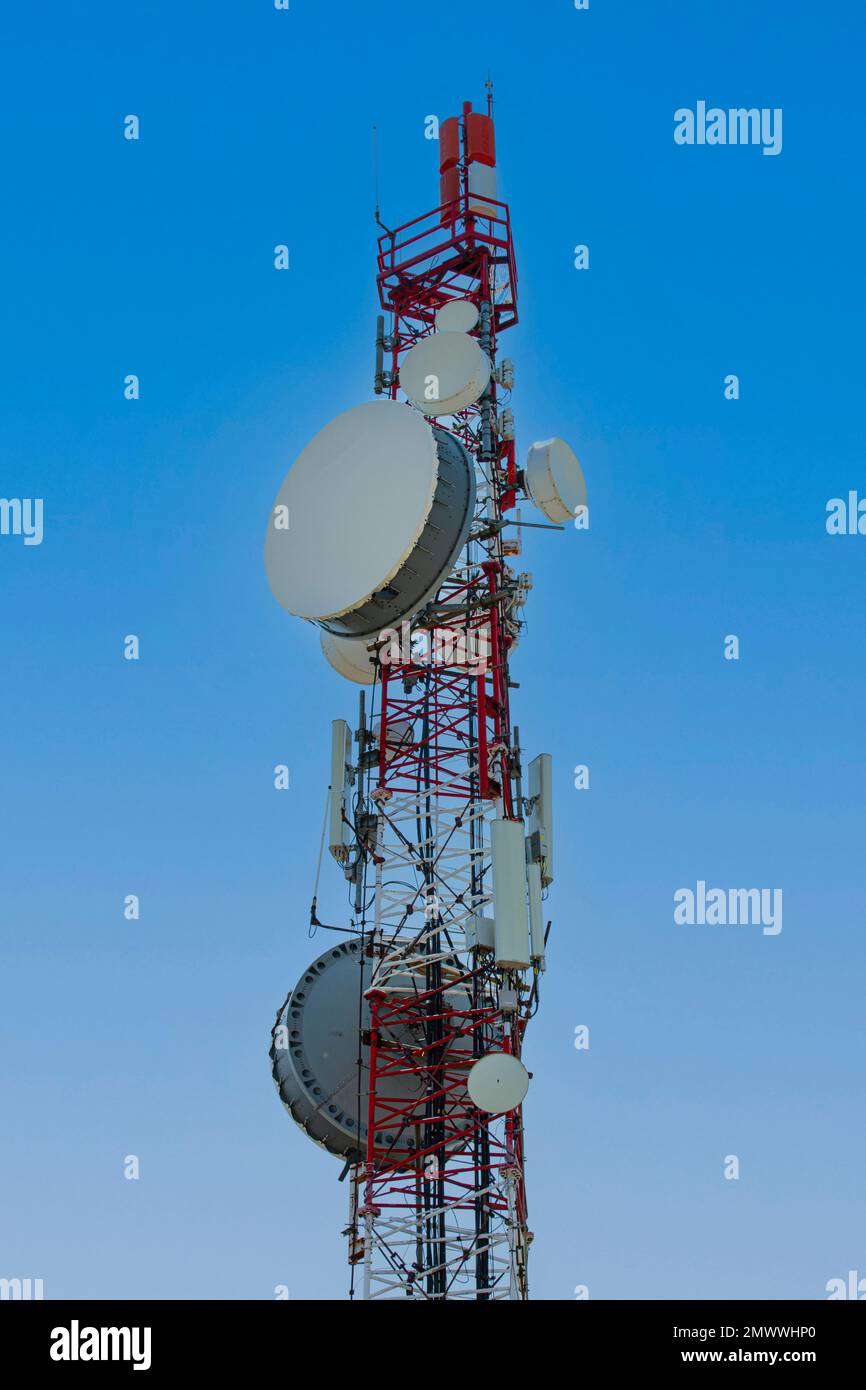 The cell tower with antenna against blue sky Stock Photo - Alamy