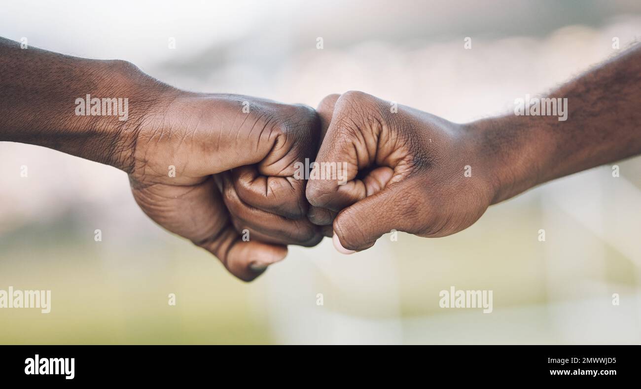 Fist bump, closeup and hands celebrating as teamwork on sports field ...