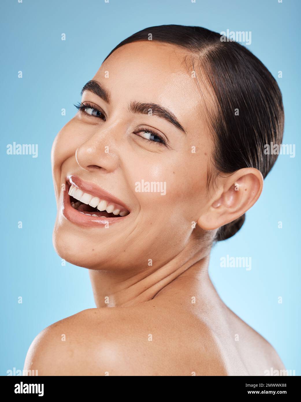 Portrait, smile and happy with a model woman in studio on a blue ...