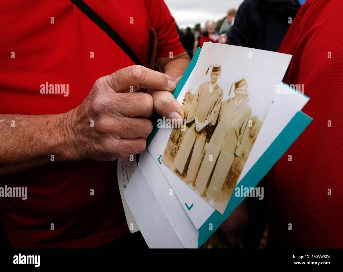 Herbert Kimble shows a copy of a graduation photograph of classmates ...